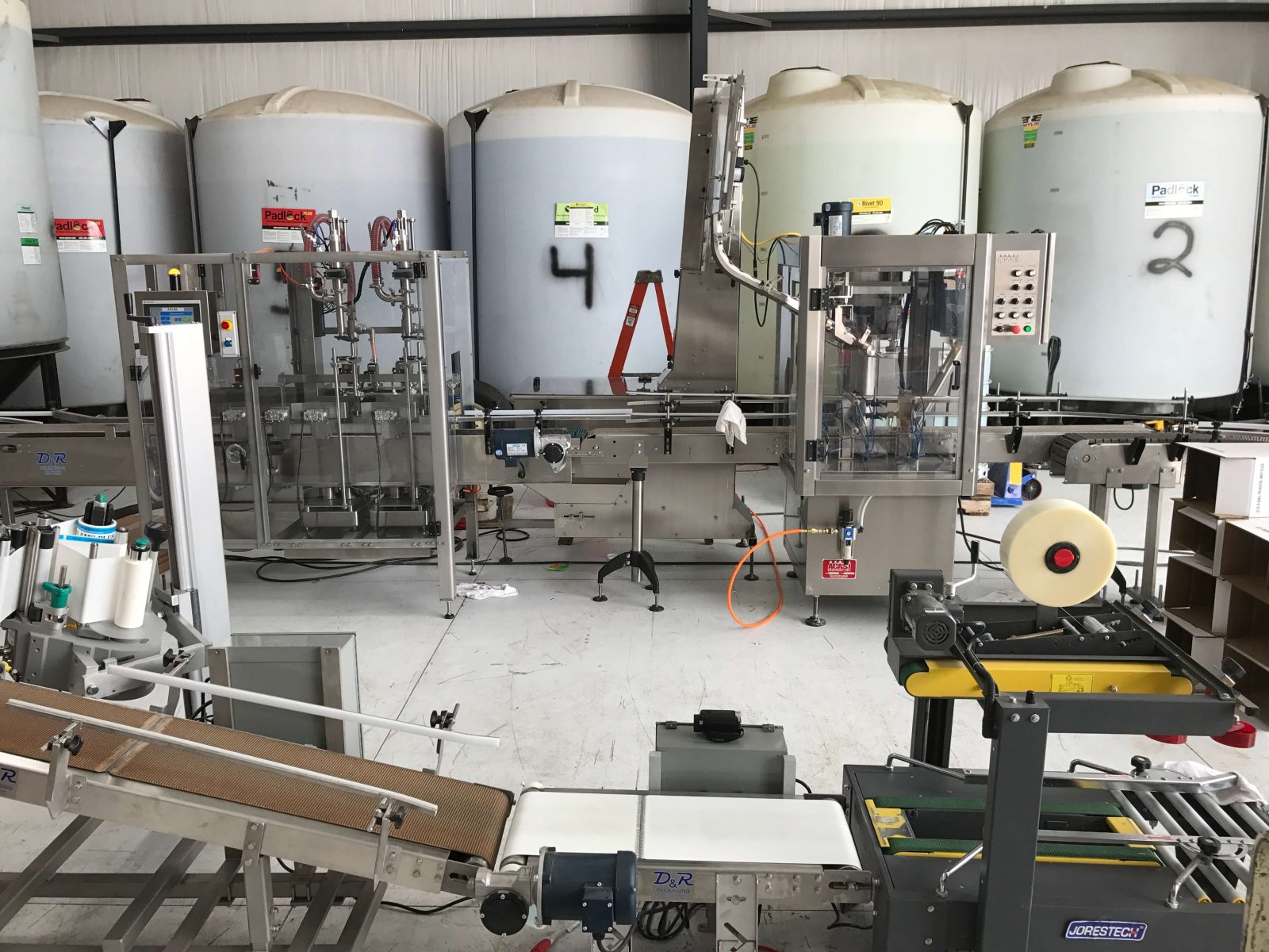 Filling Line with Two Headed Net-Weight Filler - D & R Packaging, Inc