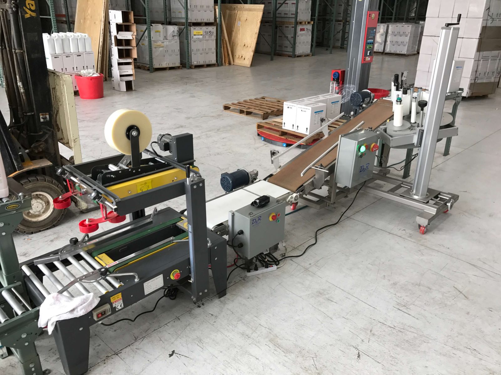 Filling Line with Two Headed Net-Weight Filler - D & R Packaging, Inc