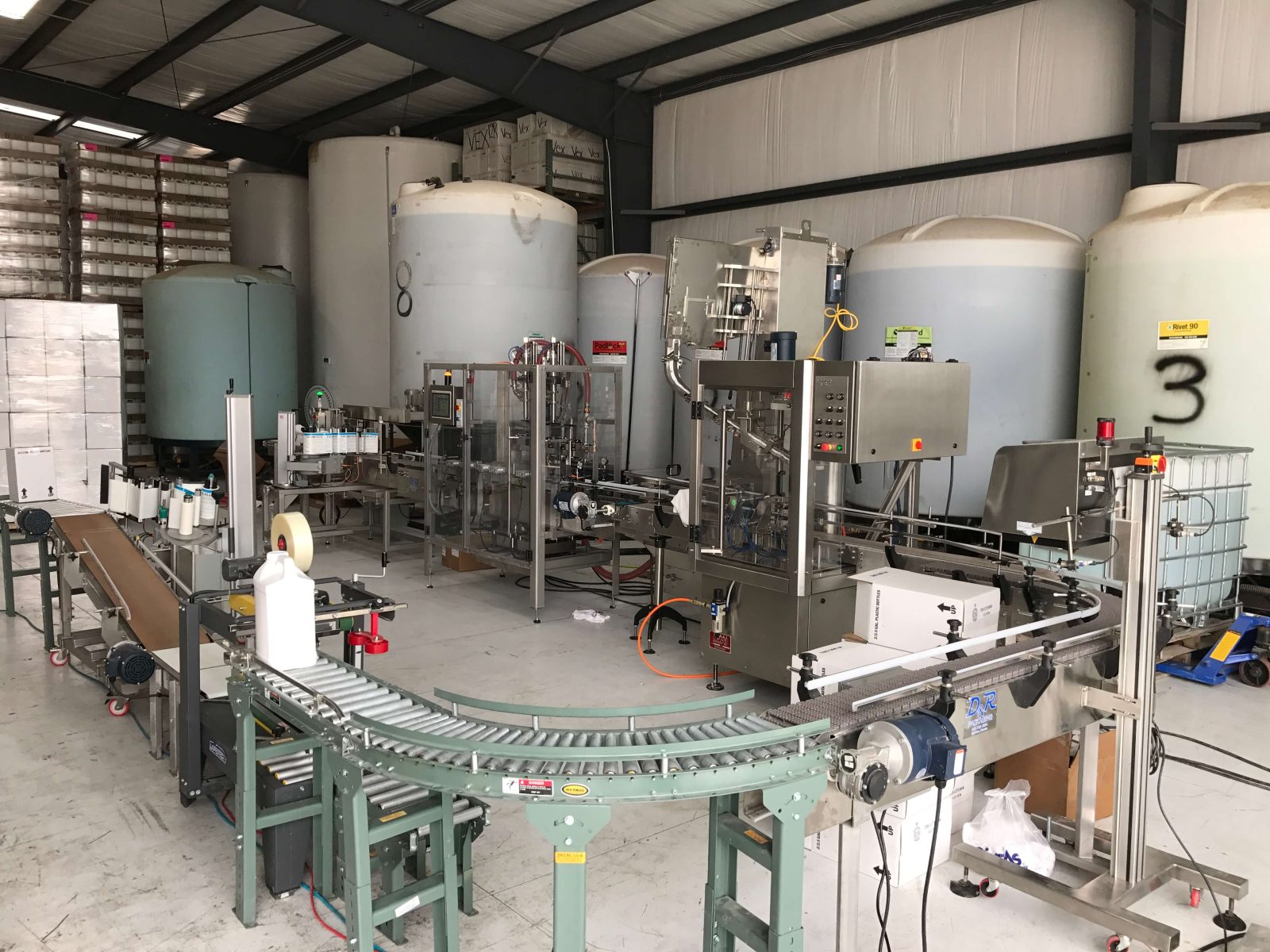 Filling Line with Two Headed Net-Weight Filler - D & R Packaging, Inc